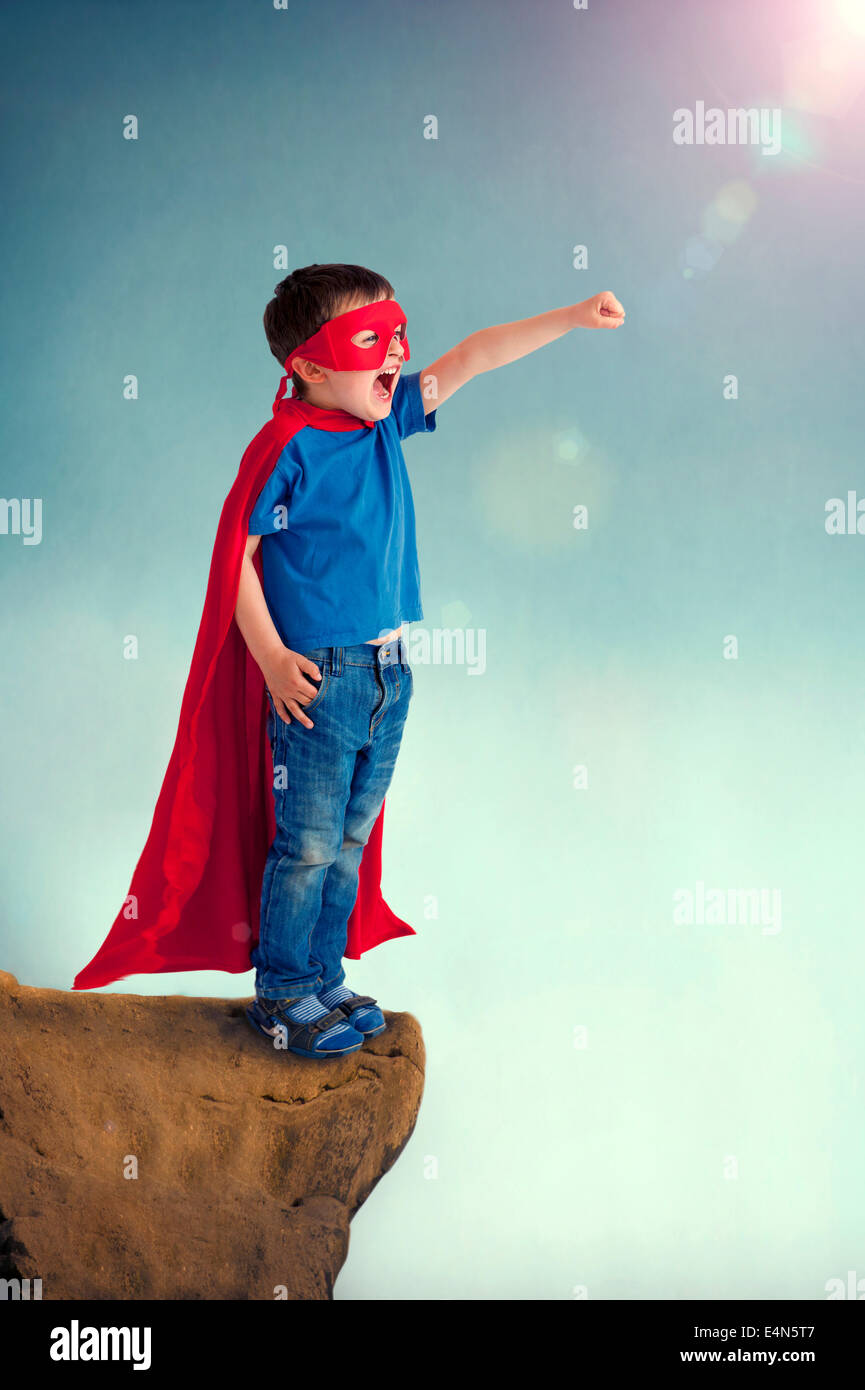 superhero boy child standing on a cliff edge Stock Photo - Alamy