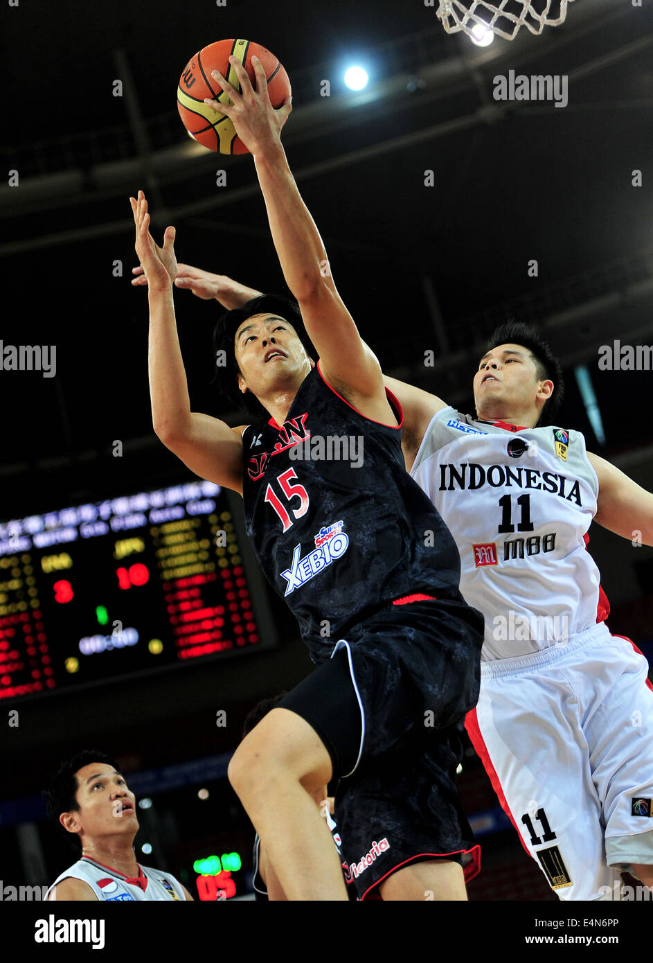 Wuhan. 15th July, 2014. Japan's Joji Takeuchi (L) goes up for a shot ...