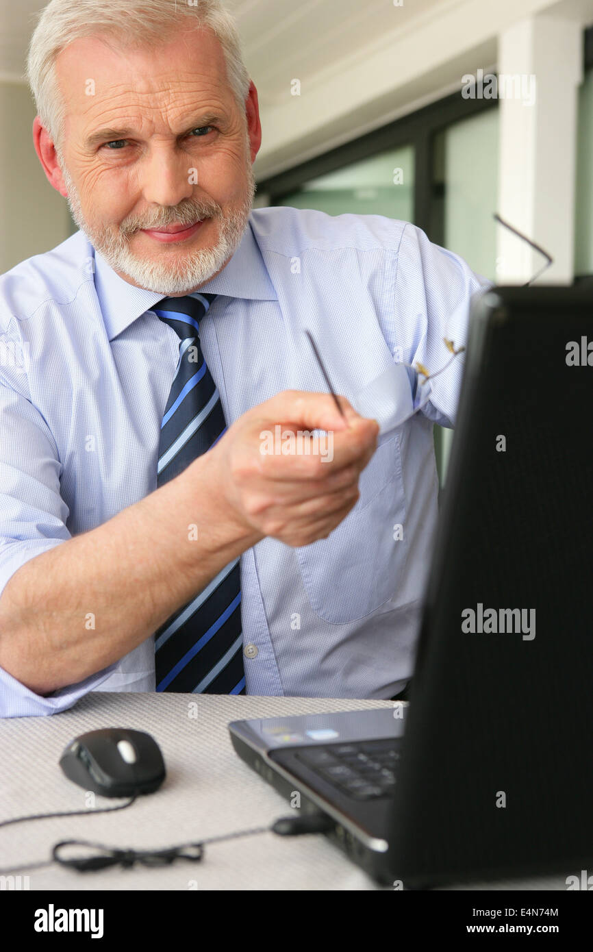 Man pointing to his laptop Stock Photo - Alamy