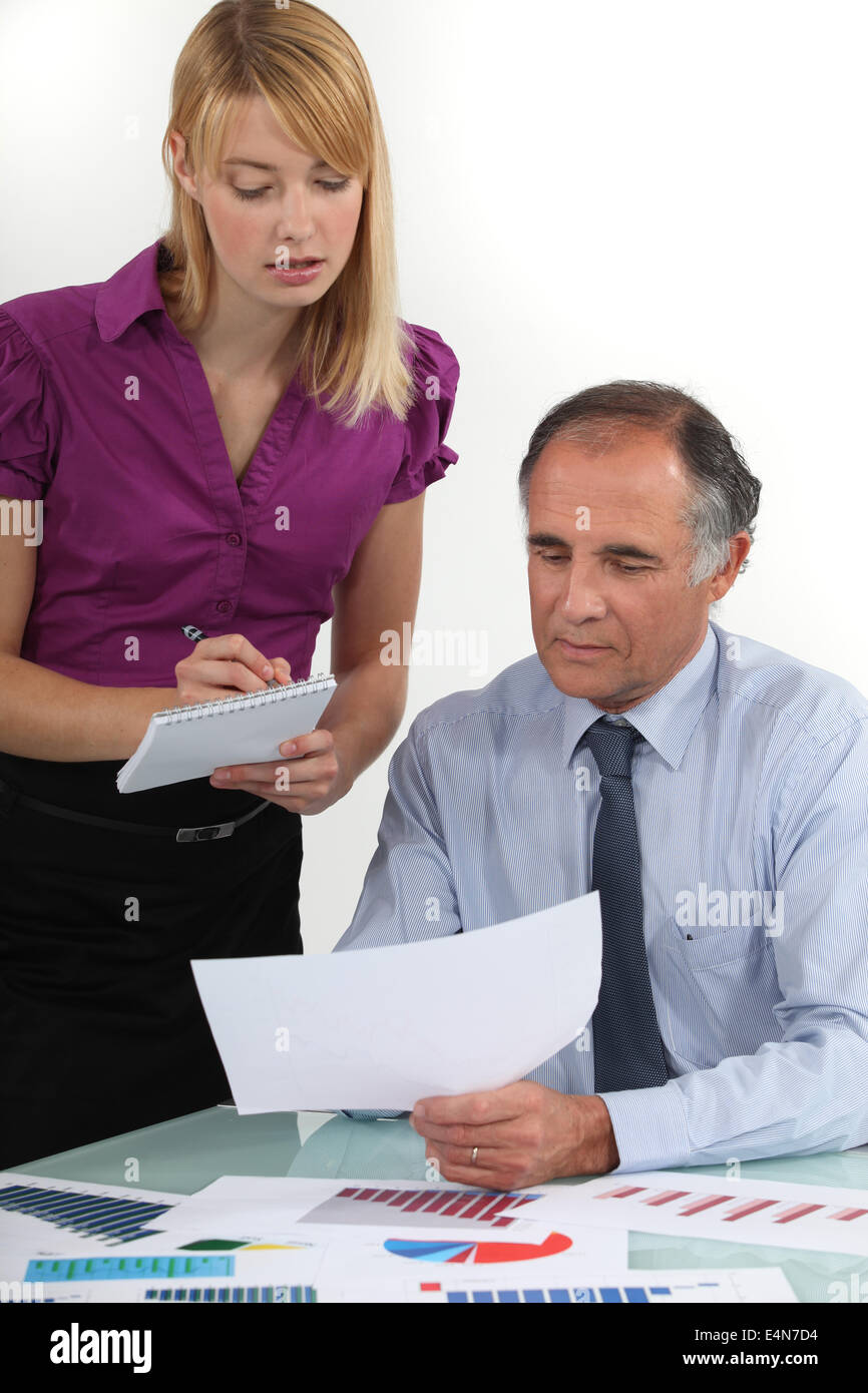 Business people looking at statistics Stock Photo - Alamy