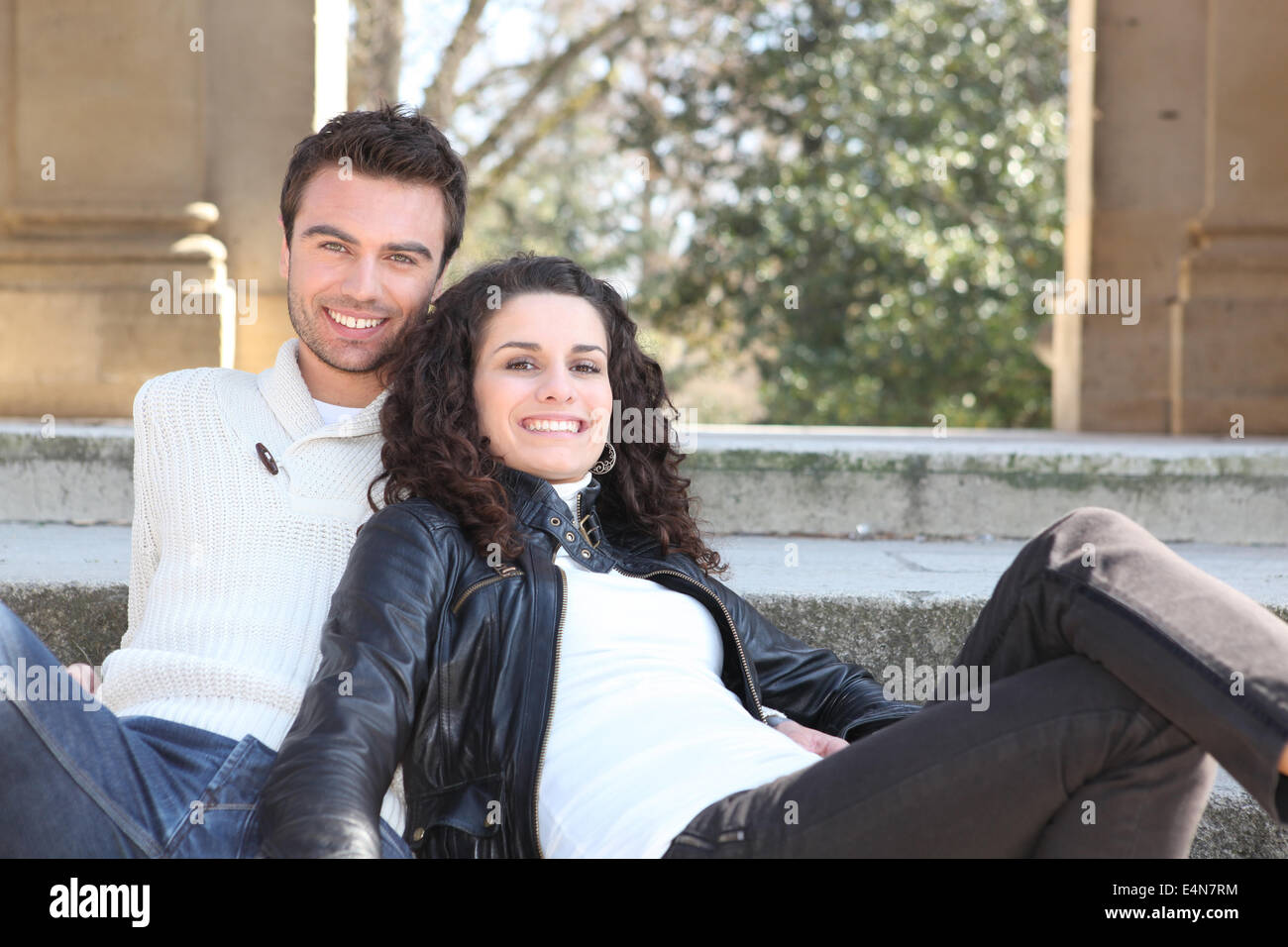 Couple sitting on steps Stock Photo - Alamy