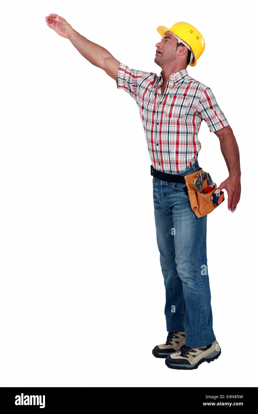 Construction worker reaching for something Stock Photo - Alamy