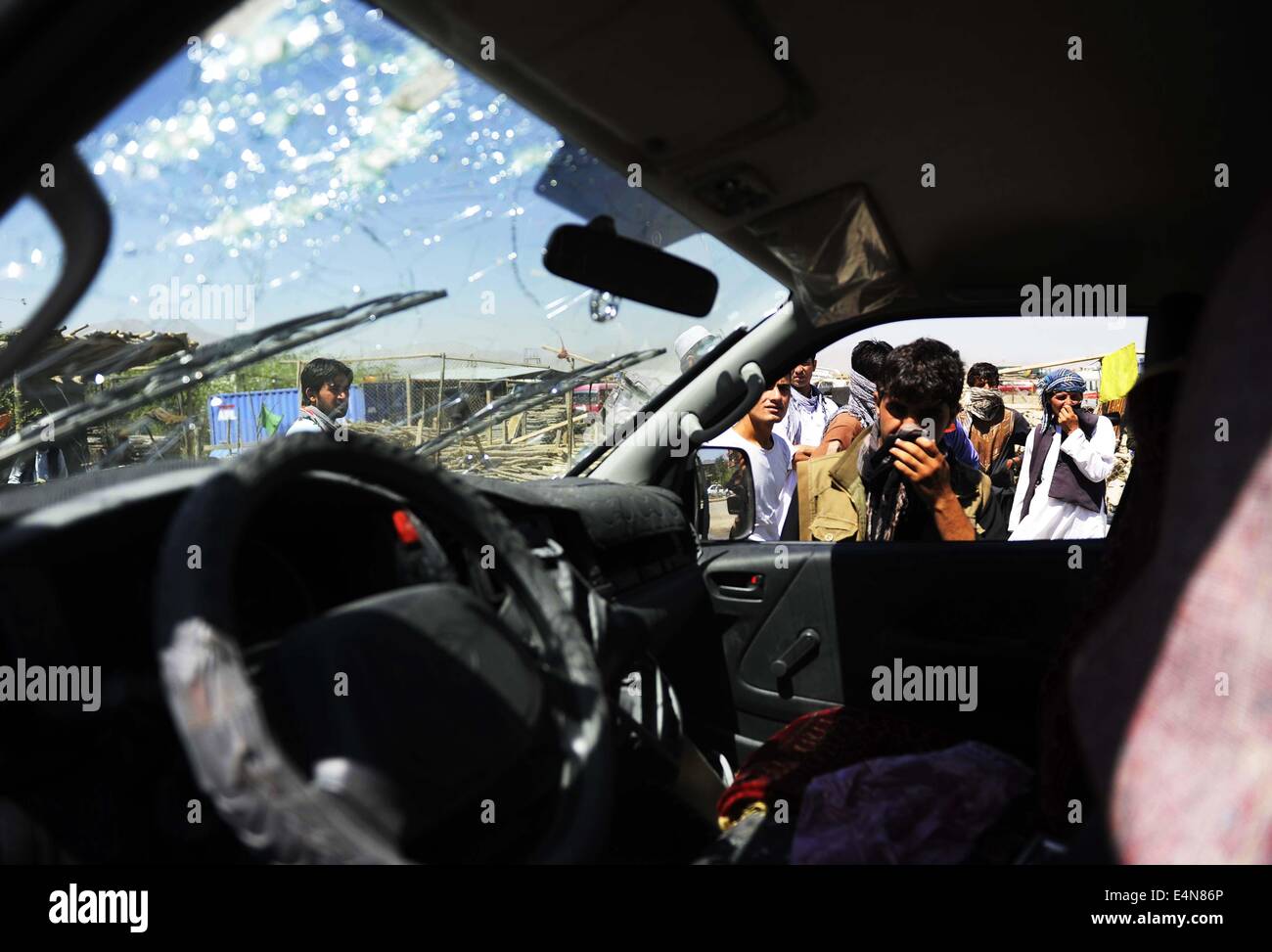 Kabul, Afghanistan. 15th July, 2014. Afghans look at the damaged bus at ...
