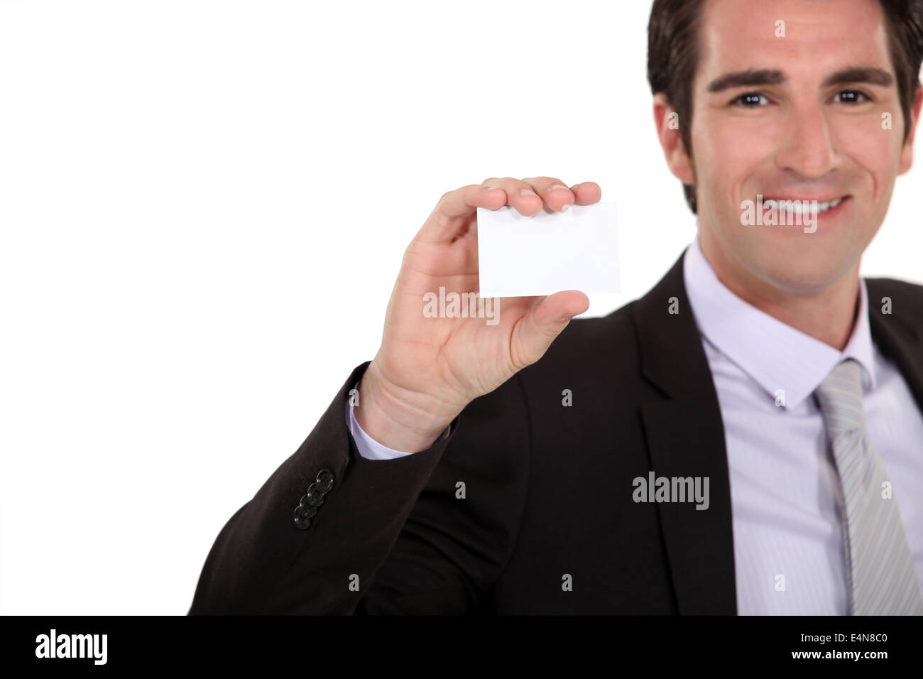 Confident businessman presenting card Stock Photo - Alamy