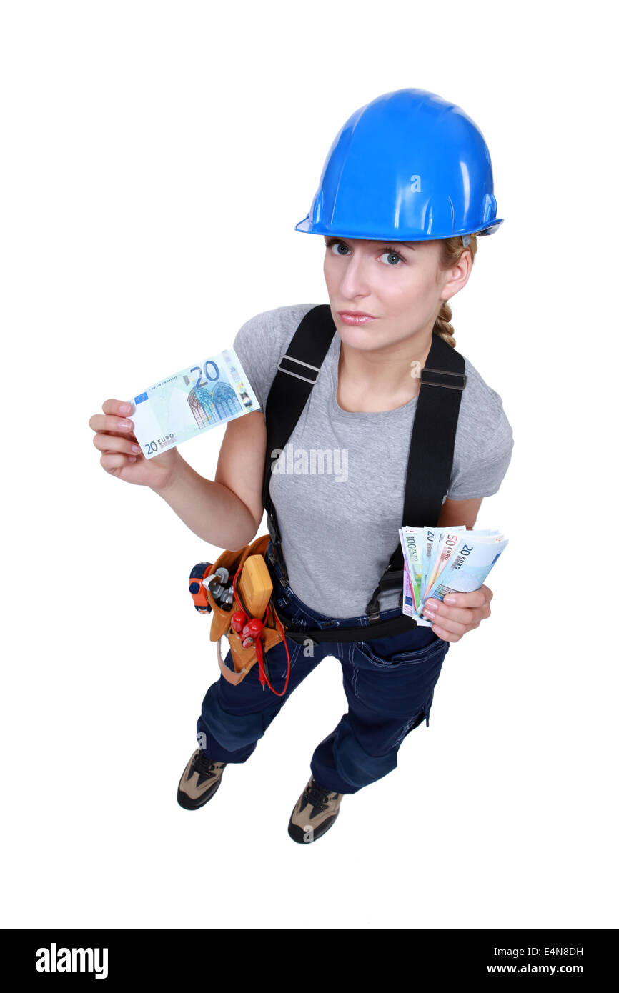 Female laborer holding wad of bills Stock Photo - Alamy