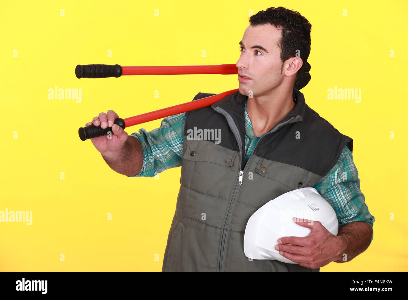 Man resting bolt-cutters on his shoulder Stock Photo - Alamy