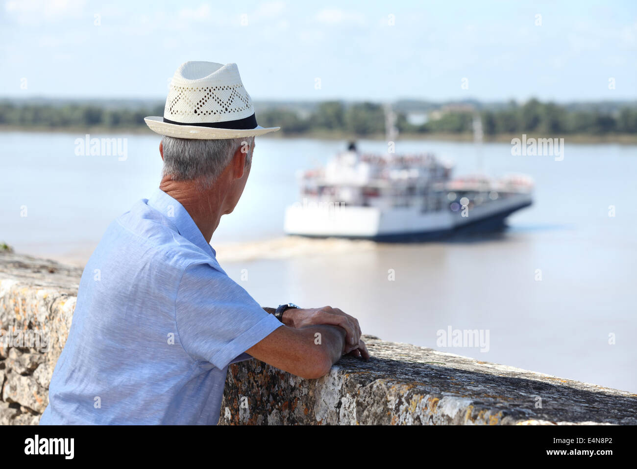 Tourist watching a ferry Stock Photo - Alamy