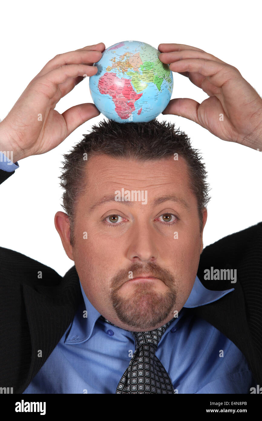 Man putting globe on his head Stock Photo - Alamy