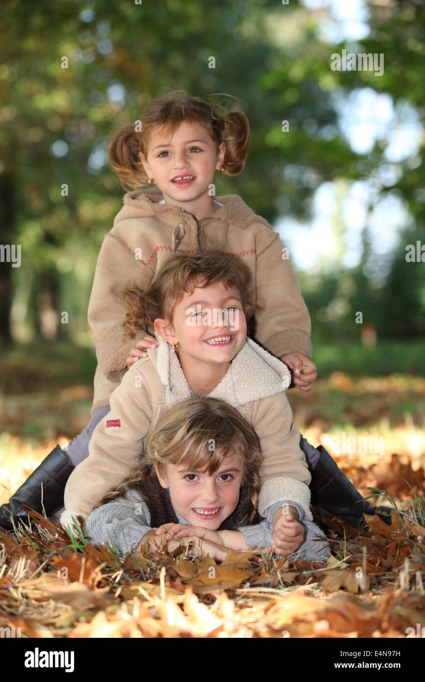 three little girls playing in the park Stock Photo - Alamy