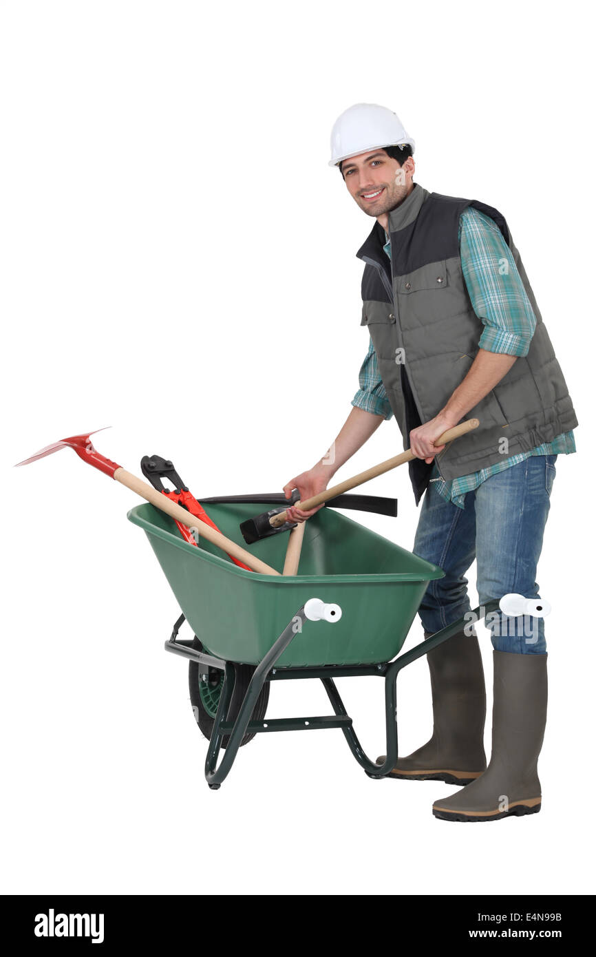 Laborer with wheelbarrow Stock Photo - Alamy