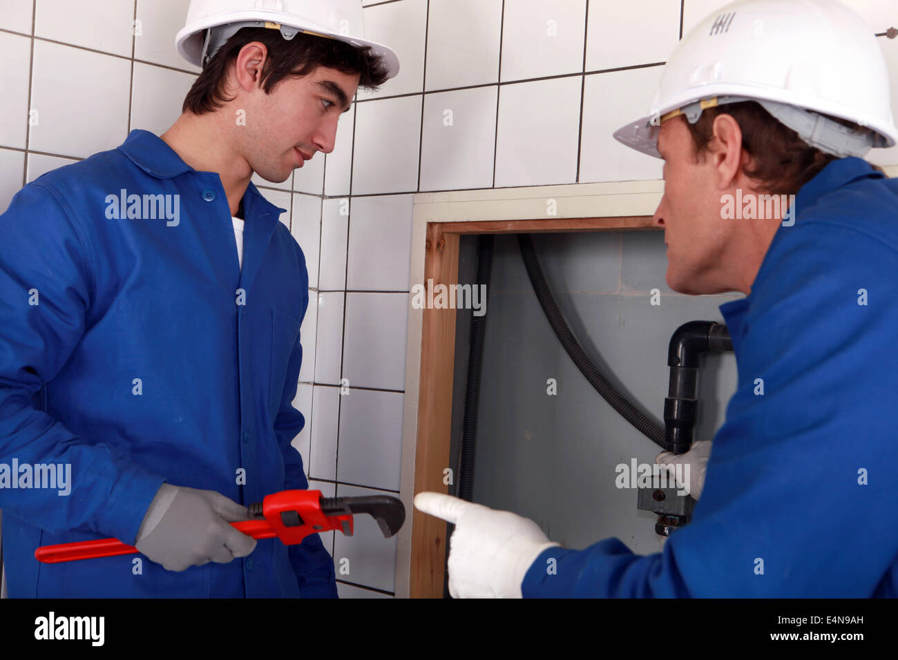 Plumber and his apprentice working together Stock Photo - Alamy