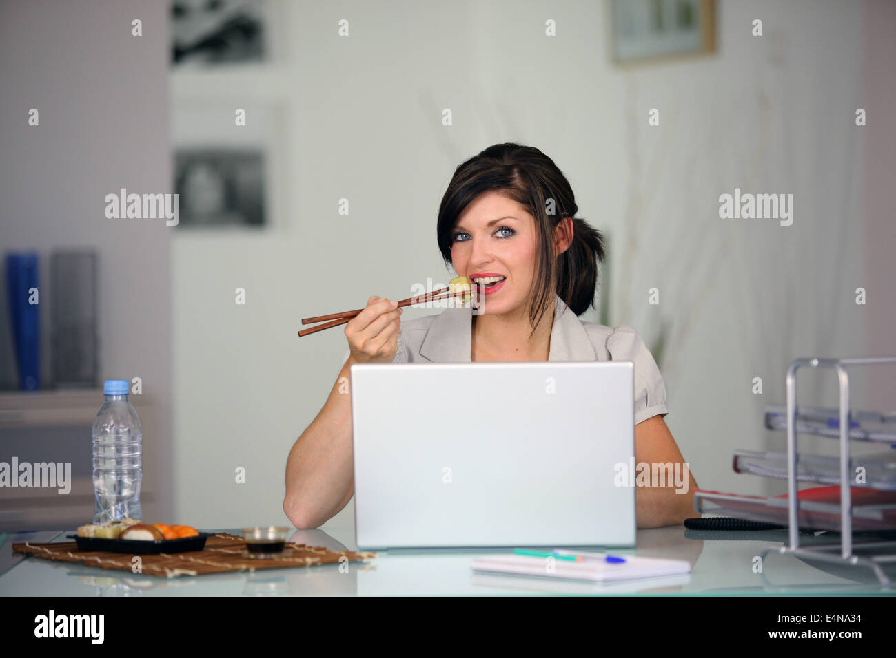 Woman eating in front of computer Stock Photo - Alamy