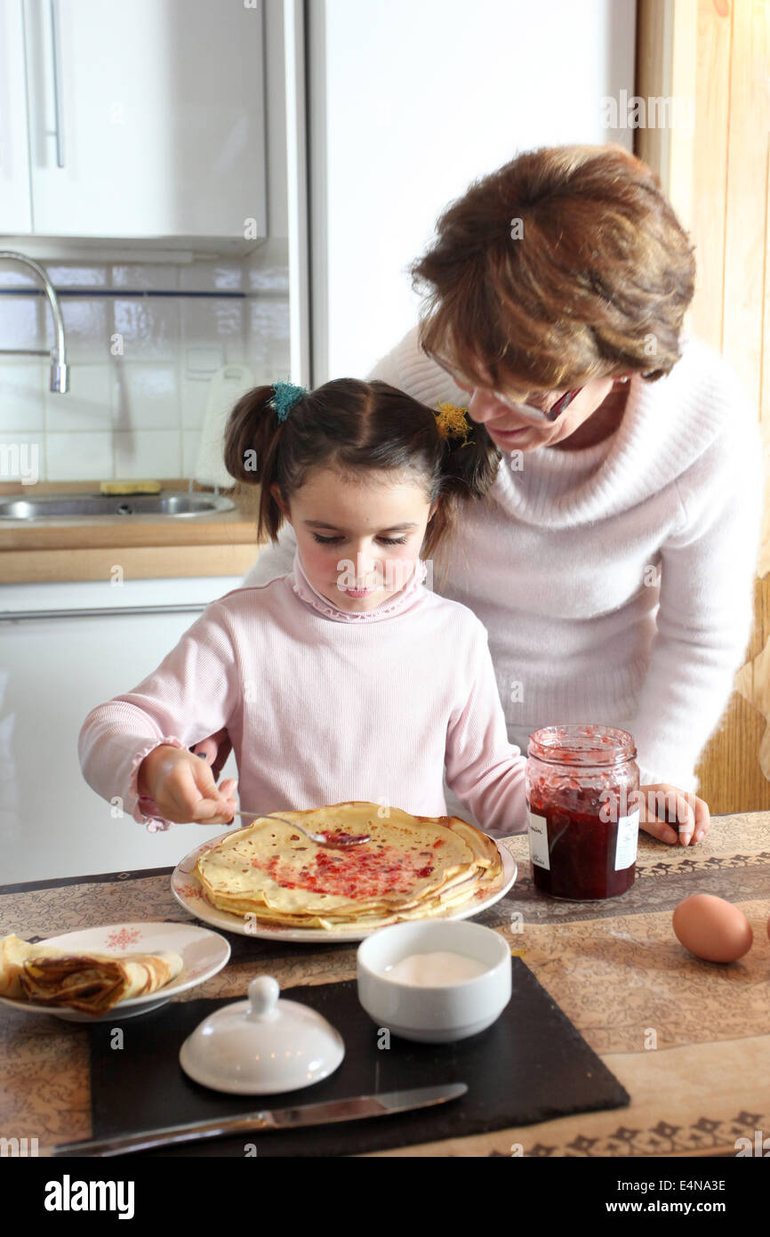 Woman and child making pancakes Stock Photo - Alamy