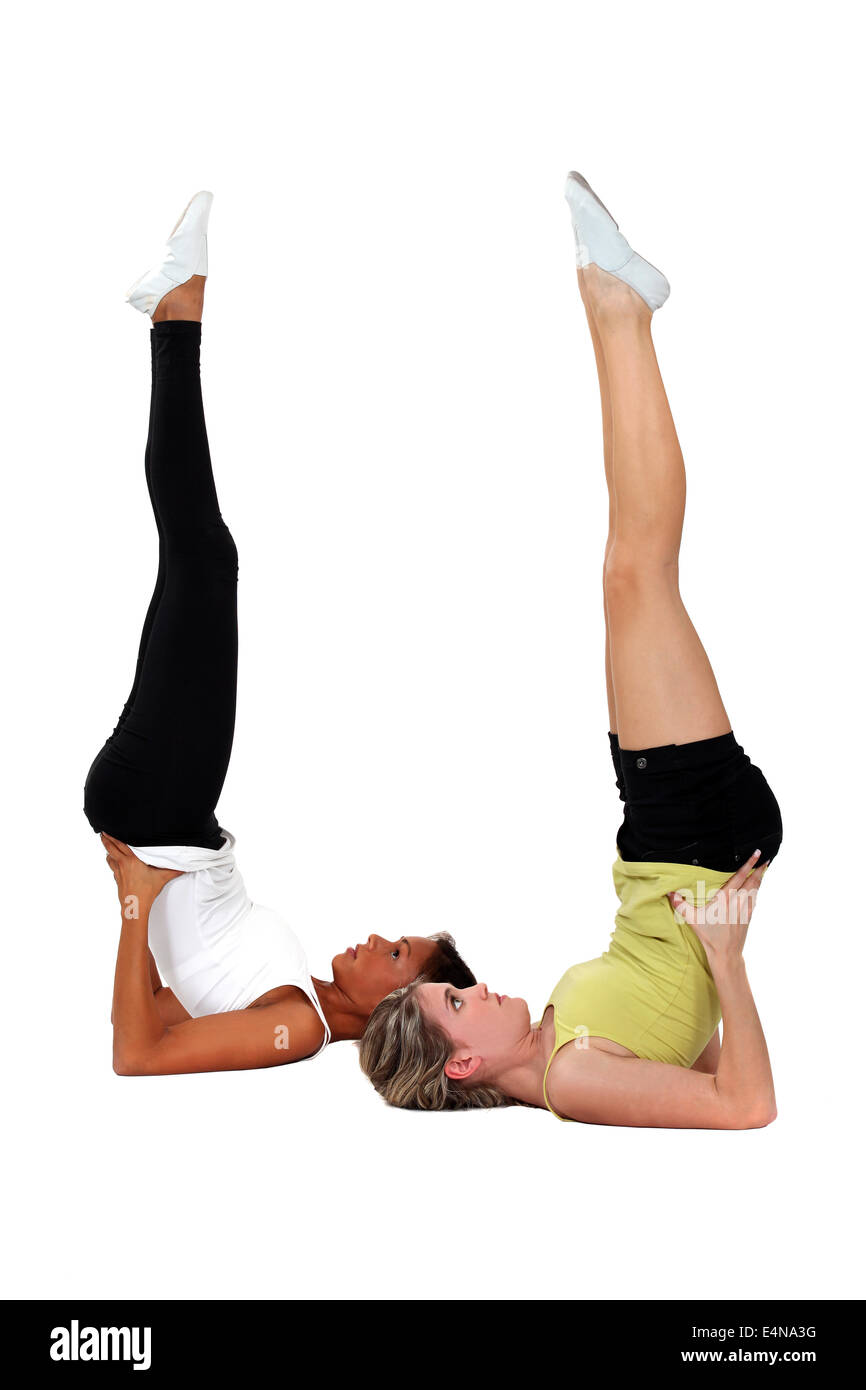 Young women performing shoulder stands Stock Photo - Alamy
