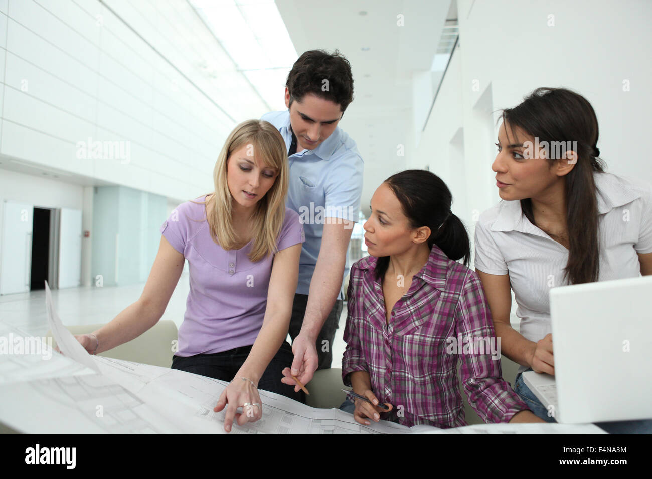 Architects consulting a blueprint Stock Photo - Alamy