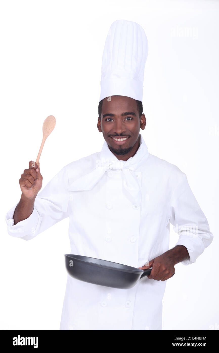 Chef with a pan and wooden spoon Stock Photo - Alamy