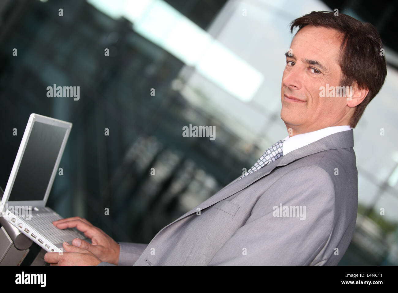 Businessman on laptop Stock Photo - Alamy
