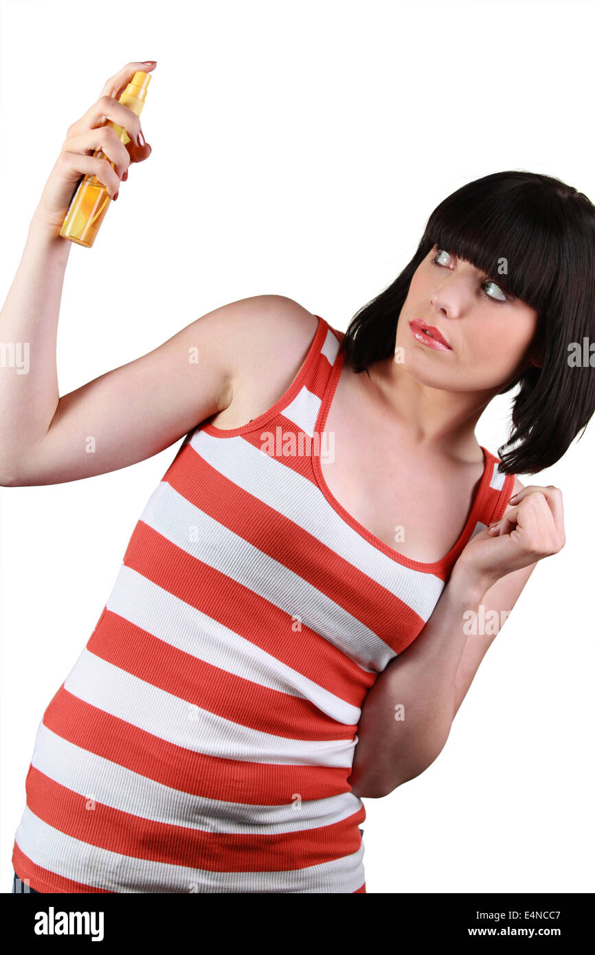 Woman holding sprayer on gray background Stock Photo - Alamy