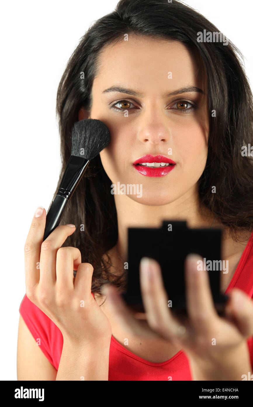 Brunette applying blusher Stock Photo - Alamy