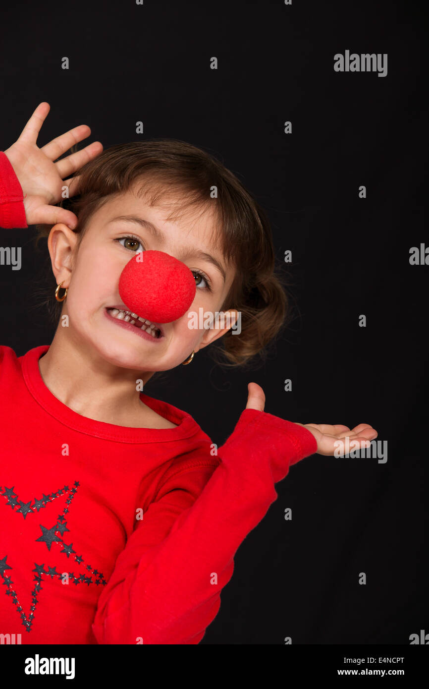 Funny little girl wearing red nose Stock Photo - Alamy
