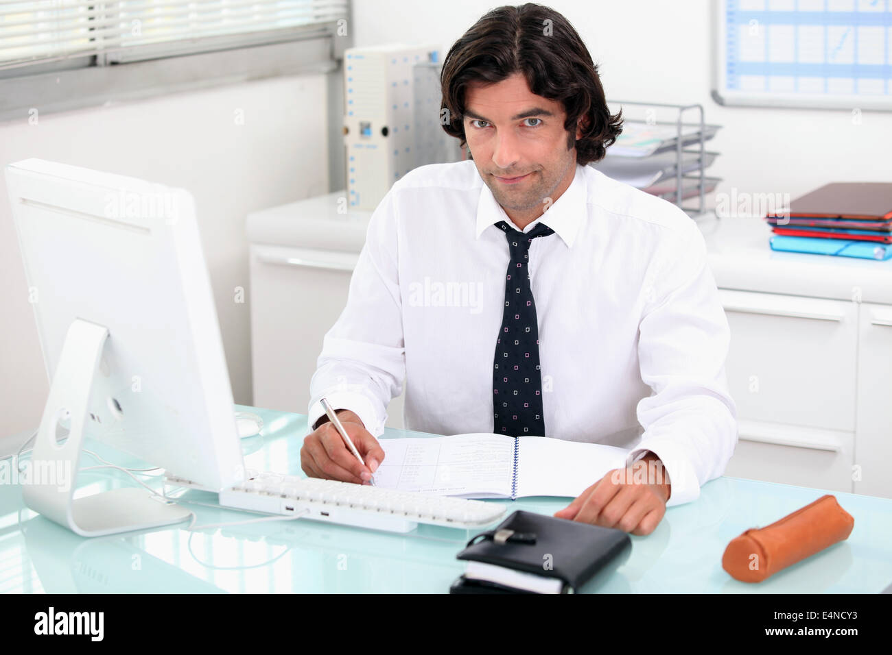Man working at his desk Stock Photo - Alamy