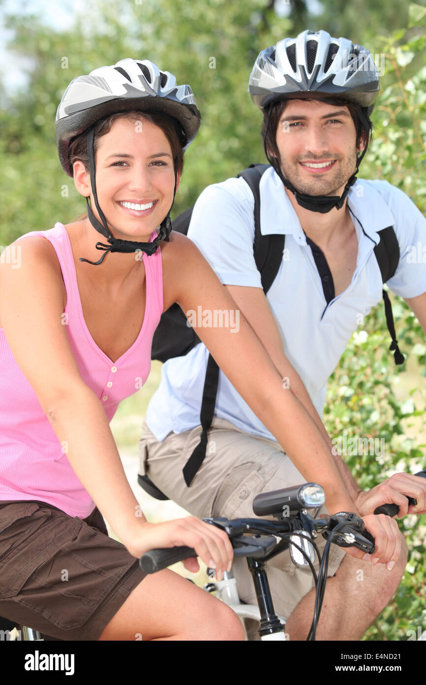 Couple riding bikes Stock Photo - Alamy