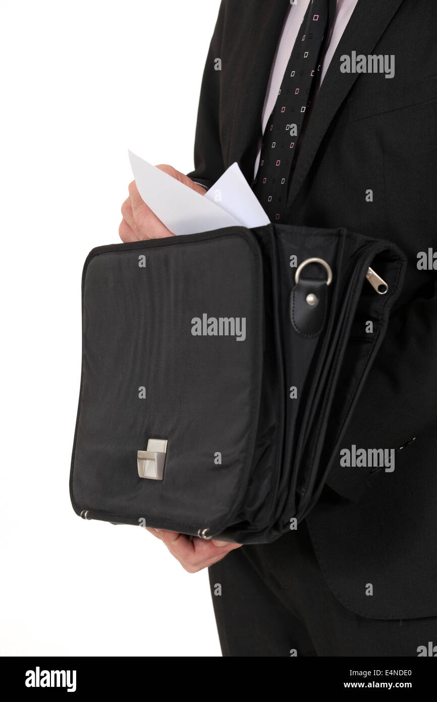 Man removing document from briefcase Stock Photo - Alamy