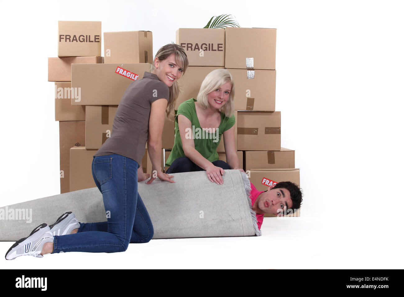 Three friends moving house Stock Photo - Alamy