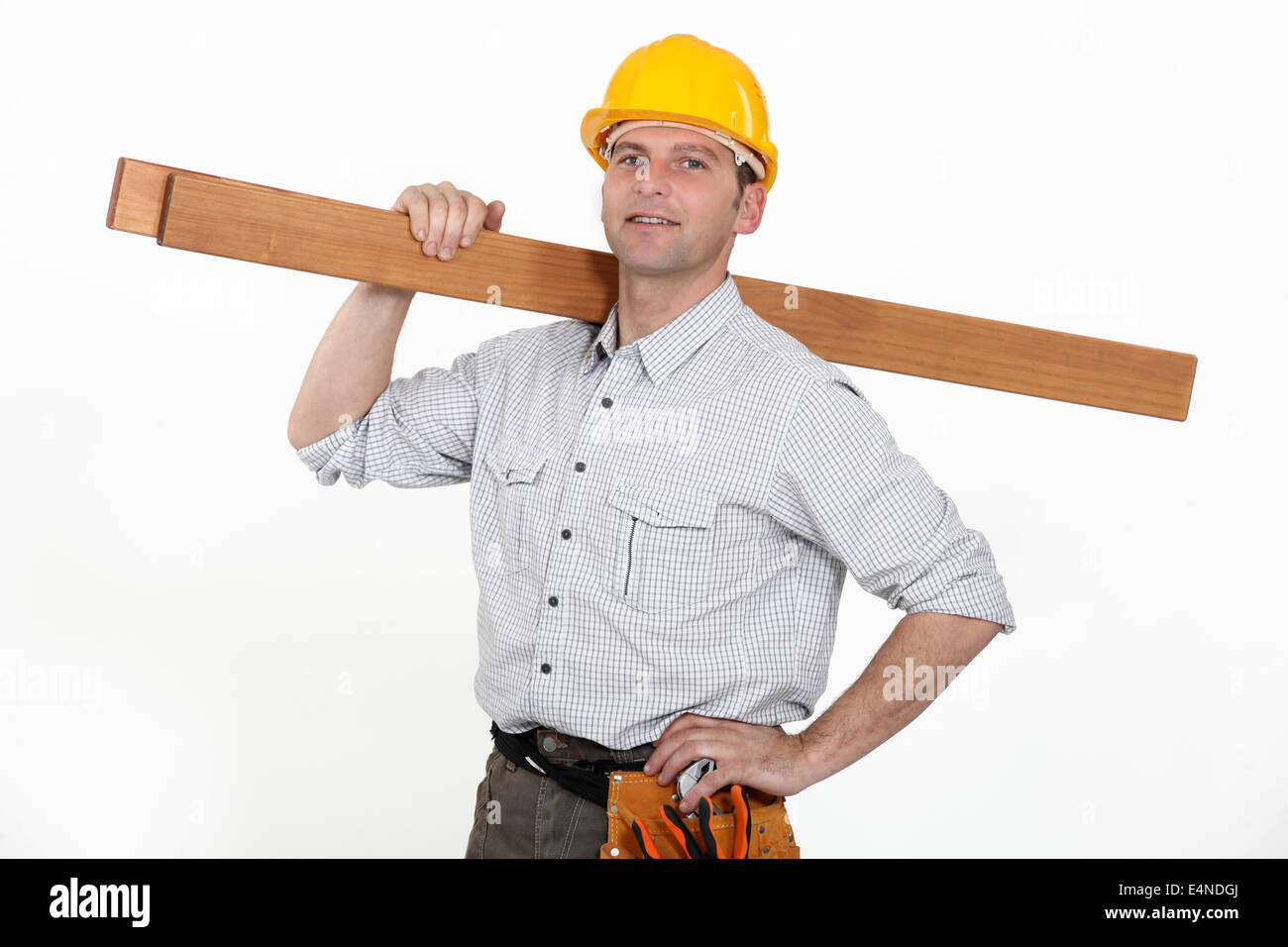 Contractor carrying timber Stock Photo - Alamy