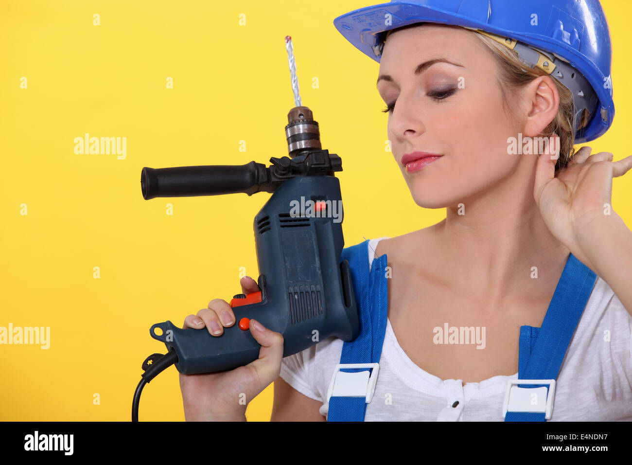 Young woman with an electric drill Stock Photo - Alamy