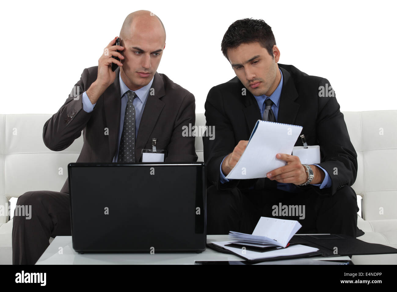 Two businessmen working together on project Stock Photo - Alamy