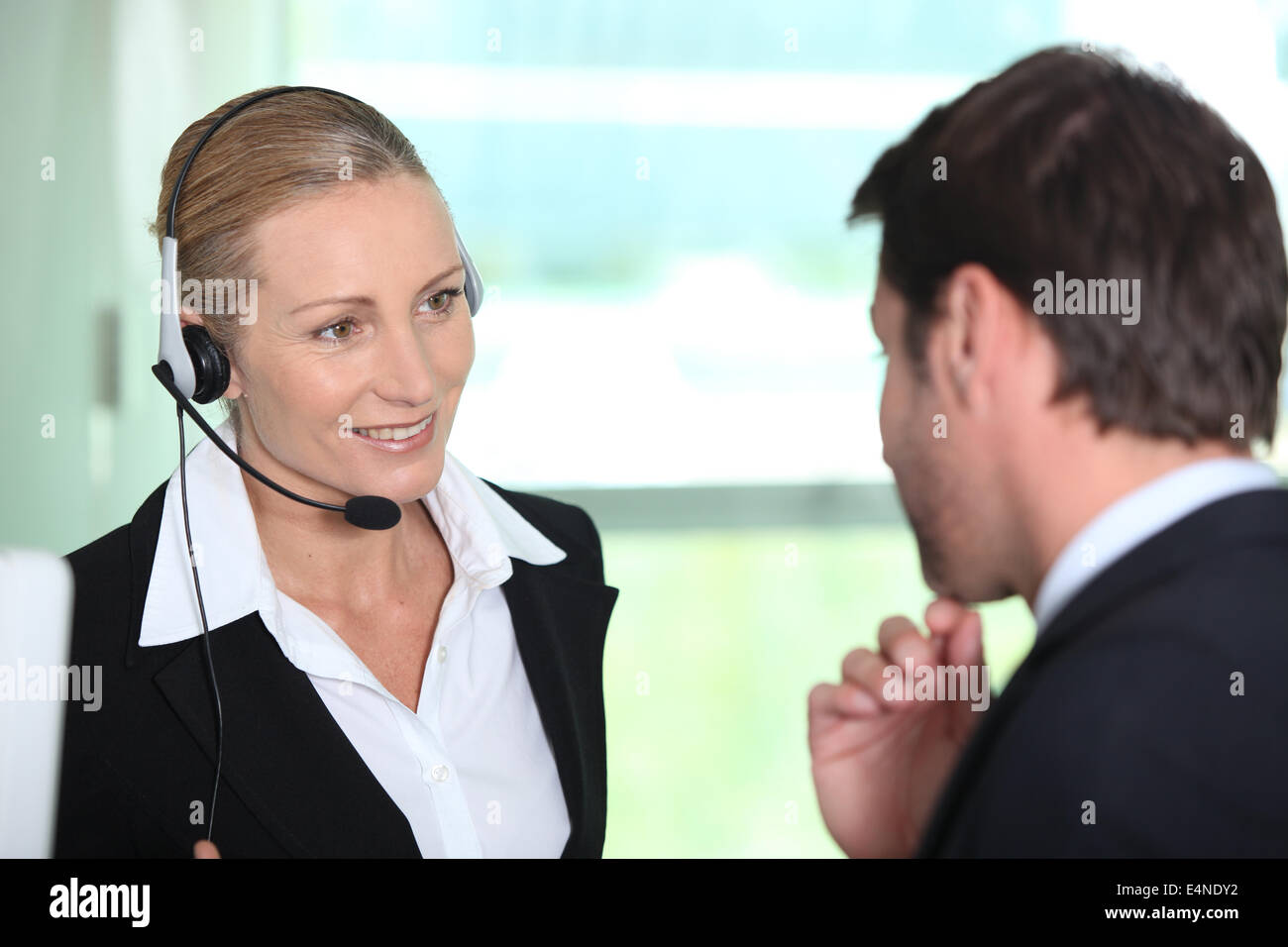 Secretary giving information to boss Stock Photo - Alamy