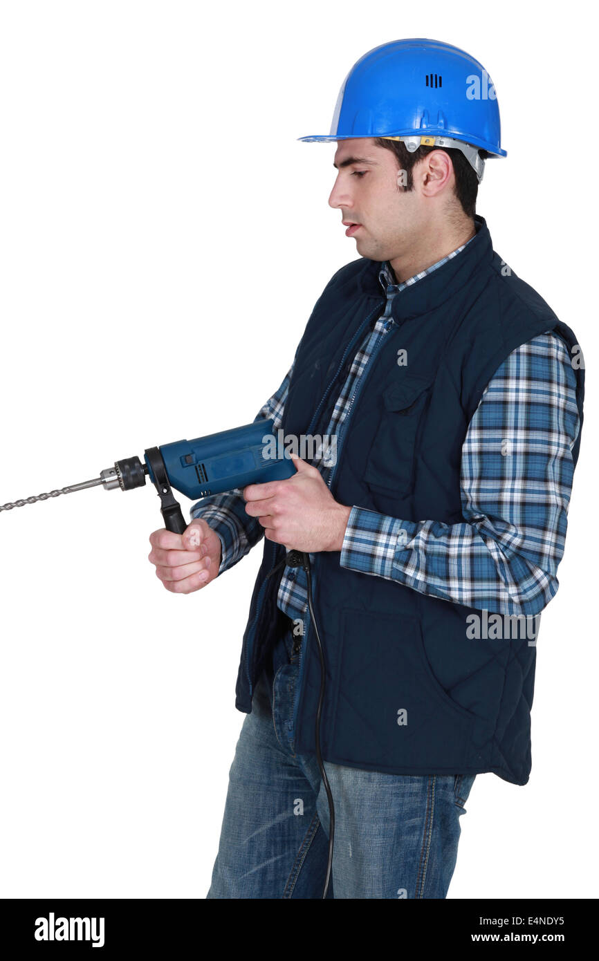 Man drilling at an angle Stock Photo - Alamy