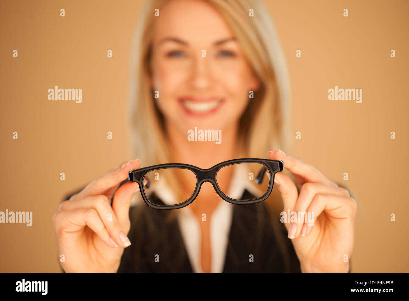 Woman holding out her spectacles Stock Photo - Alamy