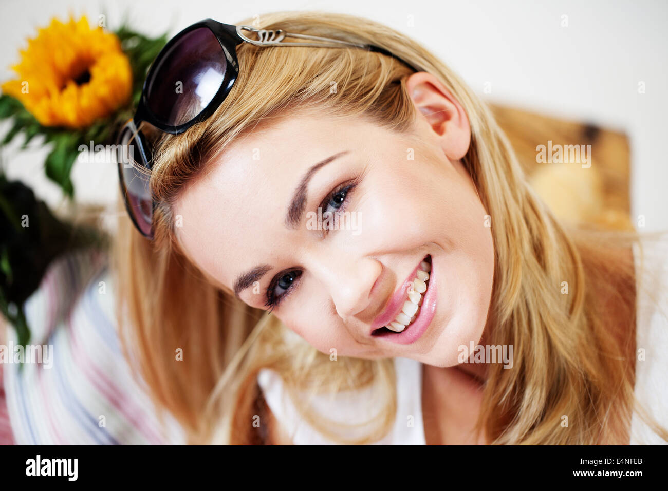 Smiling woman with sunglasses on her hair Stock Photo - Alamy