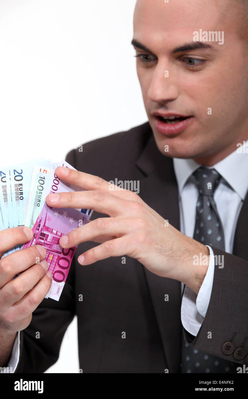 Businessman counting cash Stock Photo - Alamy