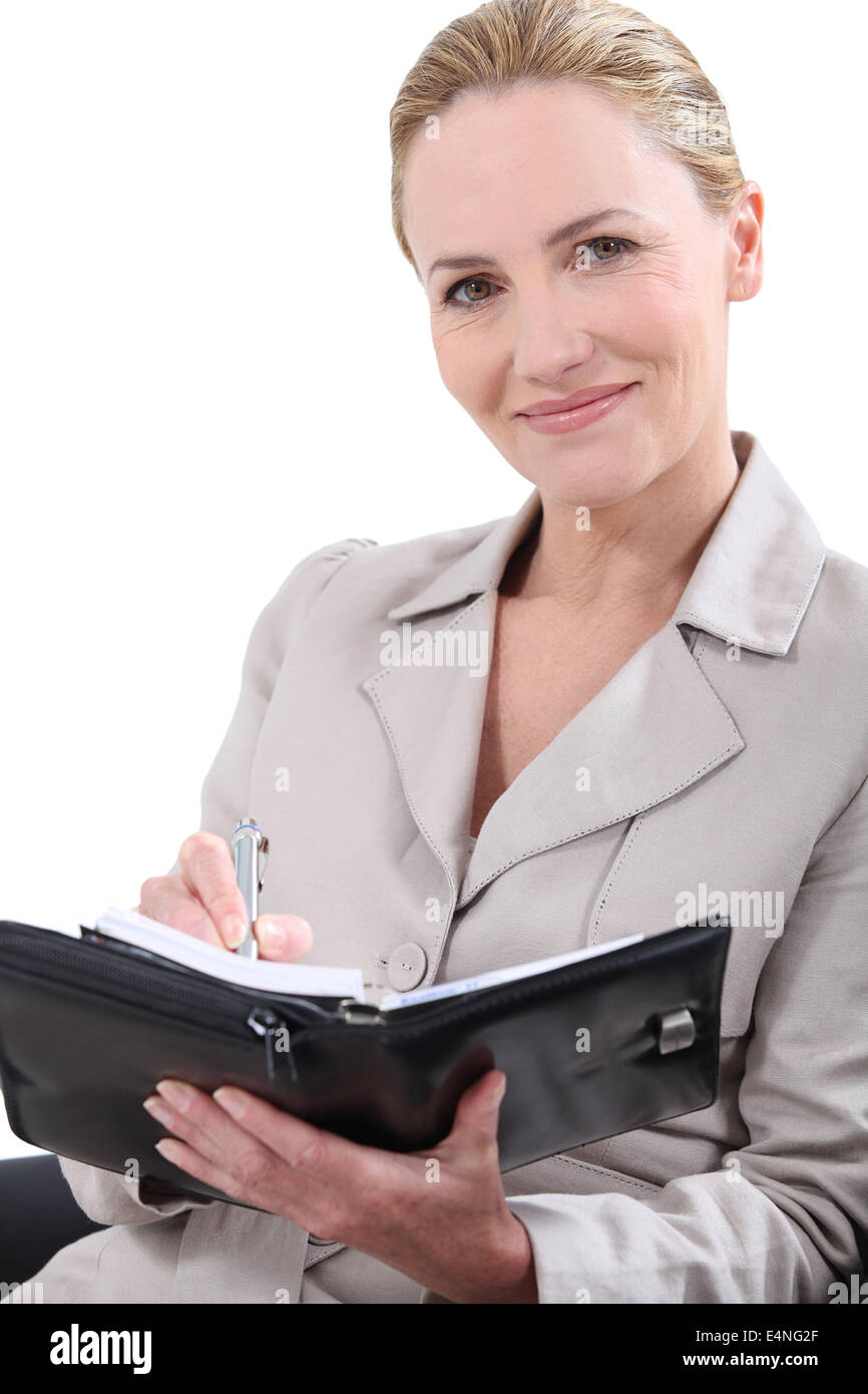 Woman writing in a personal organizer Stock Photo - Alamy