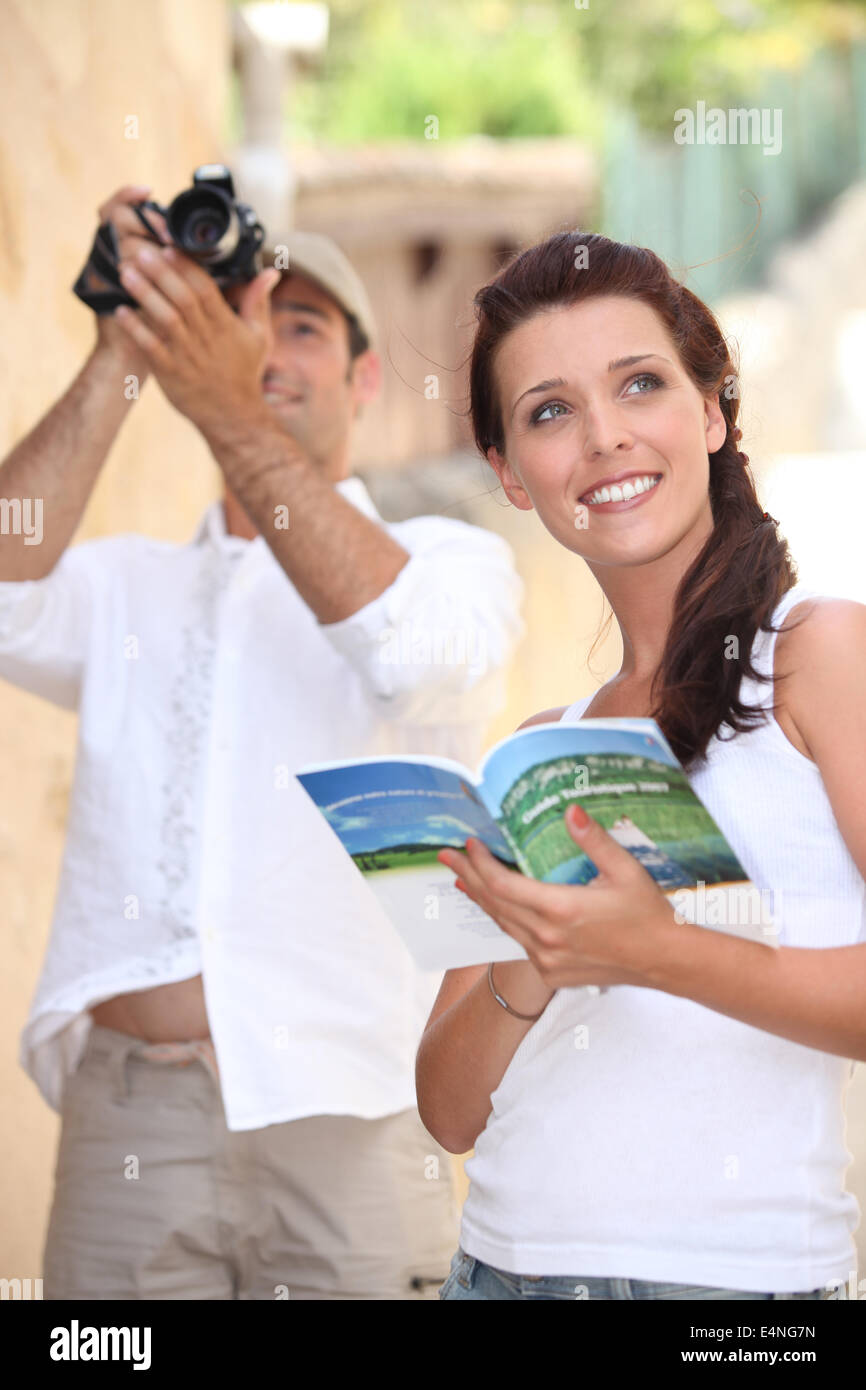 Tourists with camera and travel guide Stock Photo - Alamy