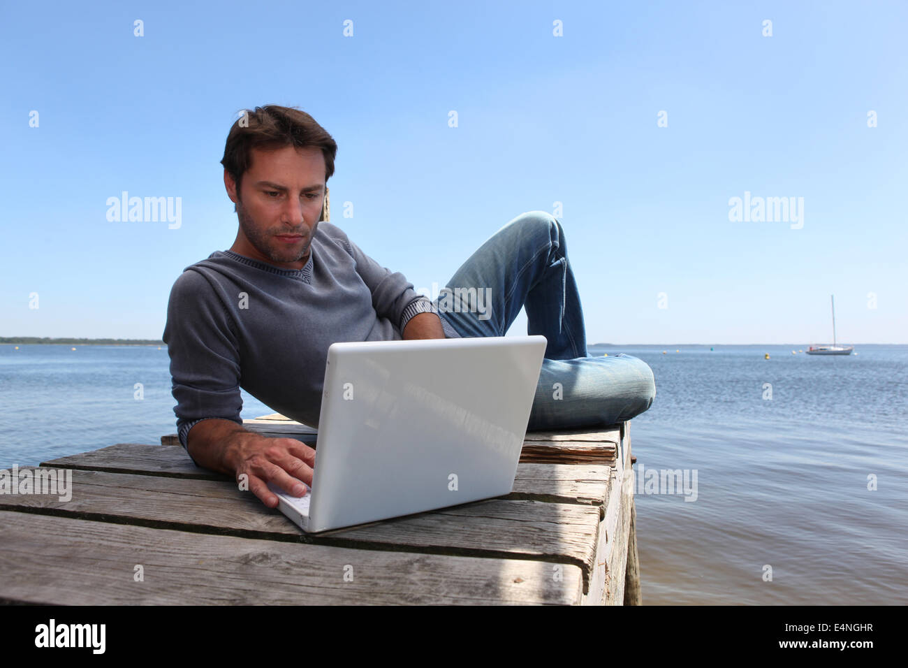 Man working on pier Stock Photo - Alamy