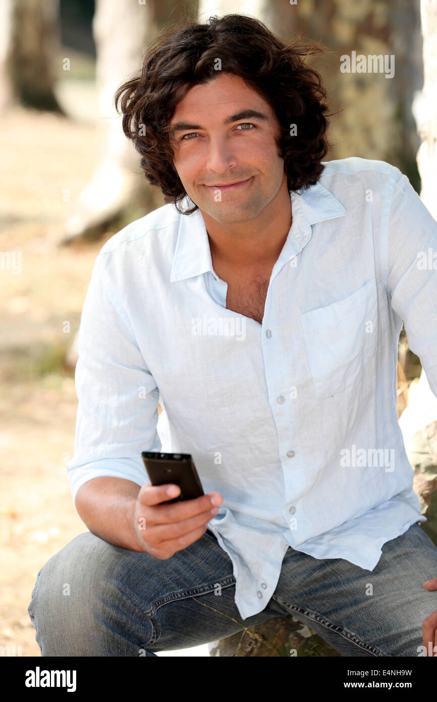 Man looking at his mobile phone Stock Photo - Alamy