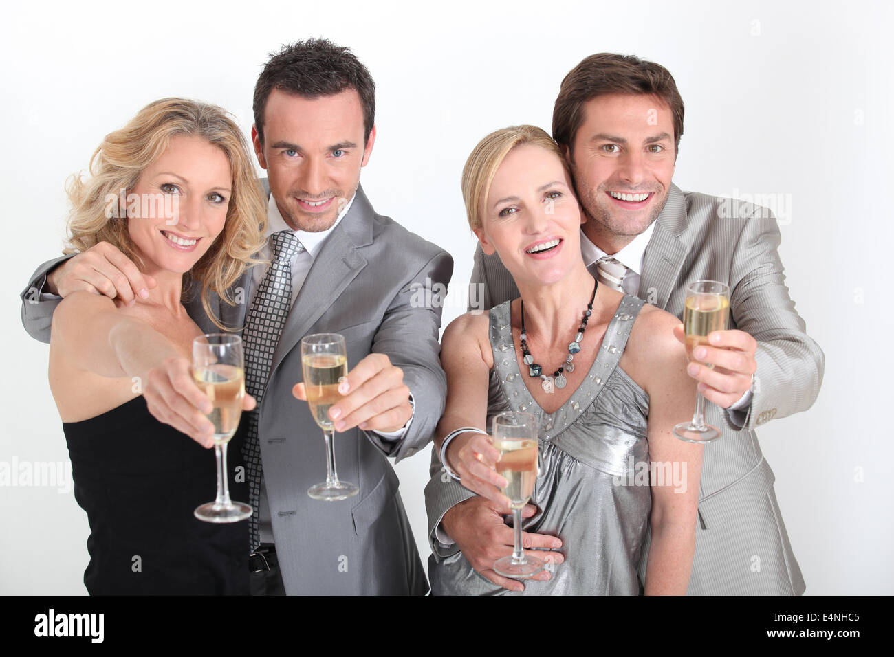 Four people celebrating Stock Photo - Alamy