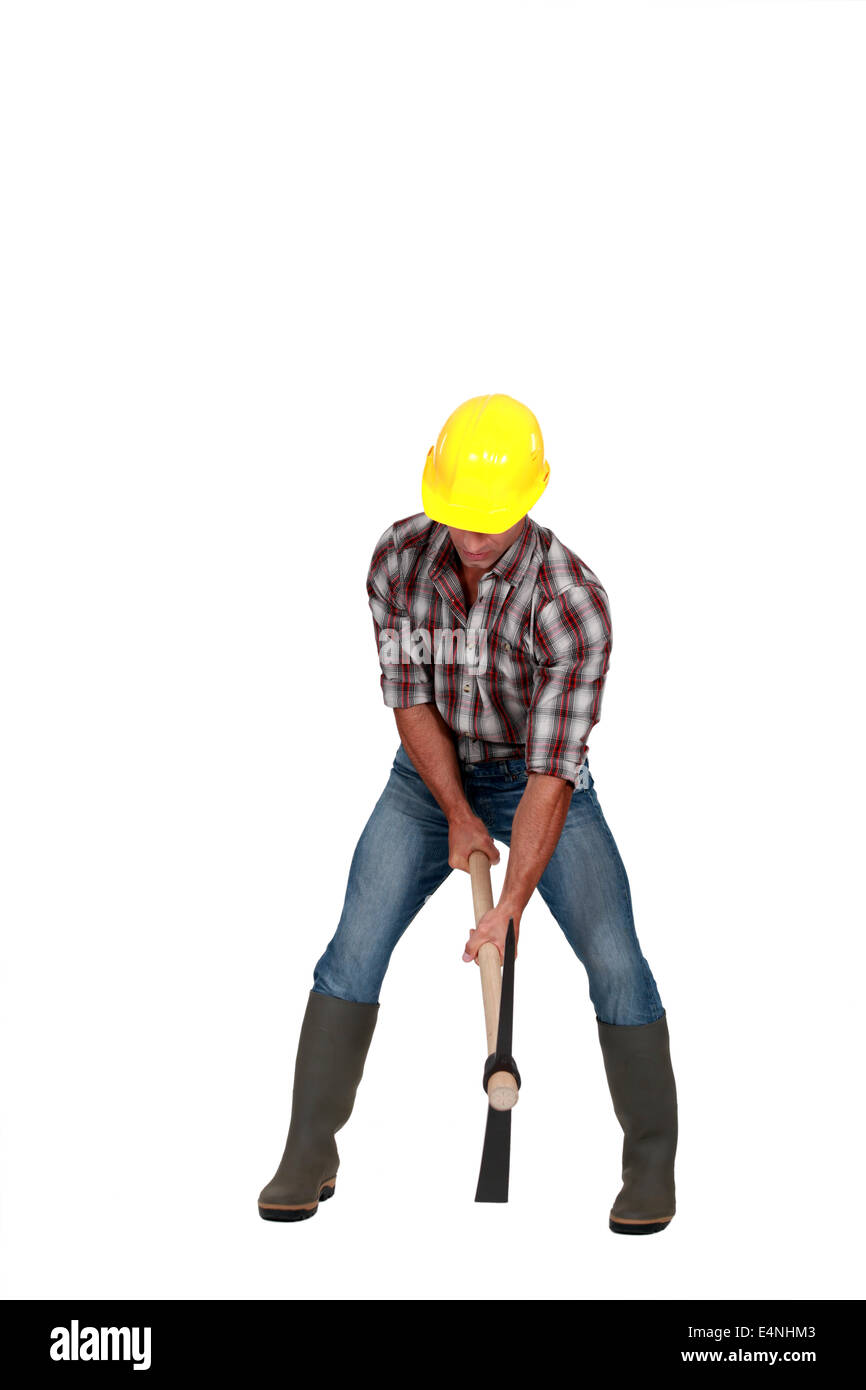 A man using a pickaxe Stock Photo - Alamy