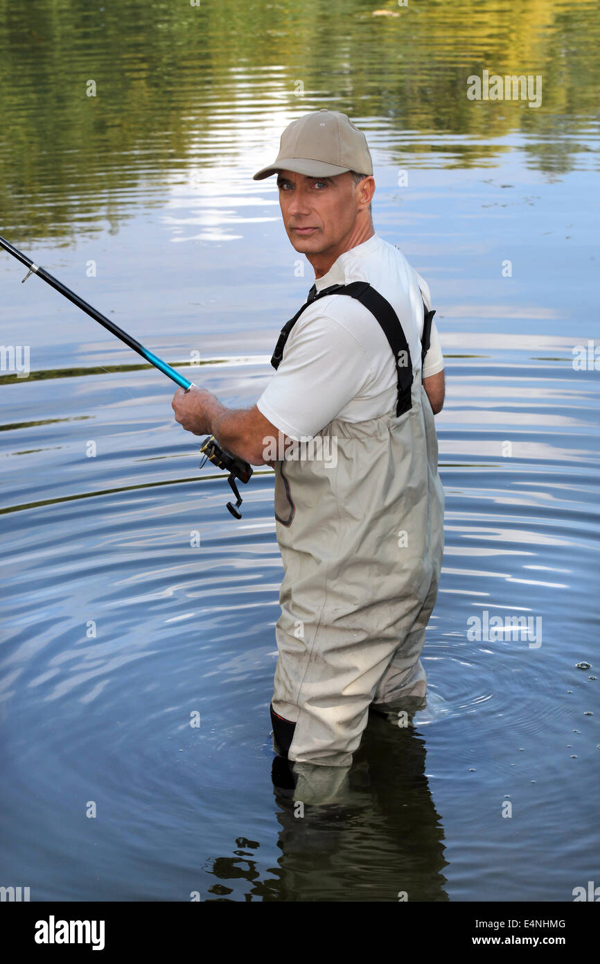 Man fishing in lake Stock Photo - Alamy