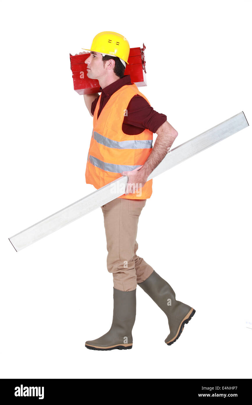 Man carrying tool-box on shoulders Stock Photo - Alamy