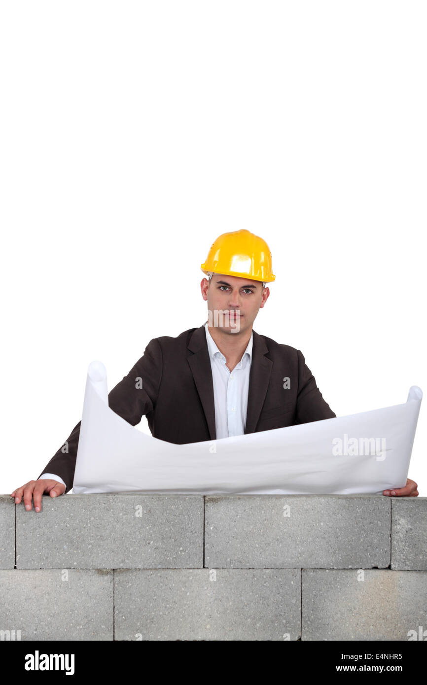 Architect looking over wall Stock Photo - Alamy