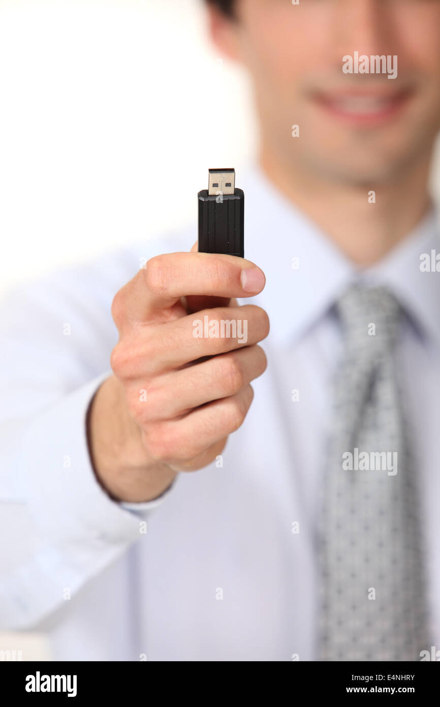 A businessman handing a USB key Stock Photo - Alamy