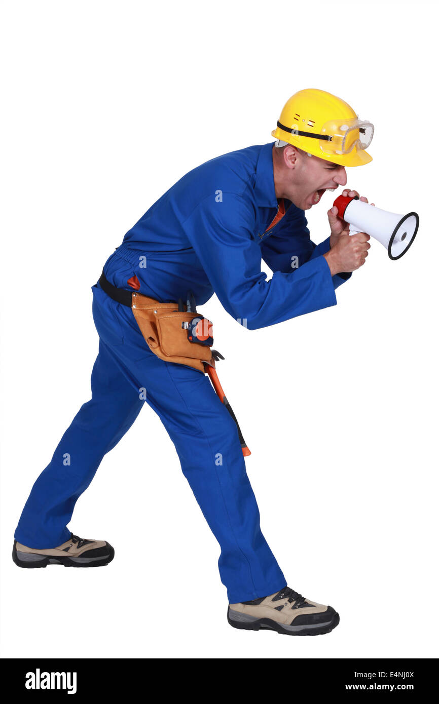 Builder screaming into megaphone Stock Photo - Alamy