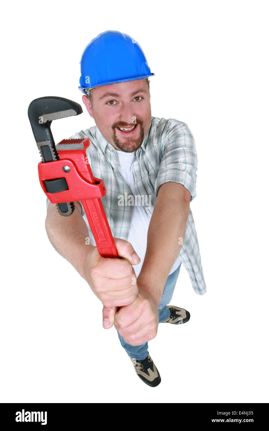 Chubby plumber holding adjustable wrench Stock Photo - Alamy