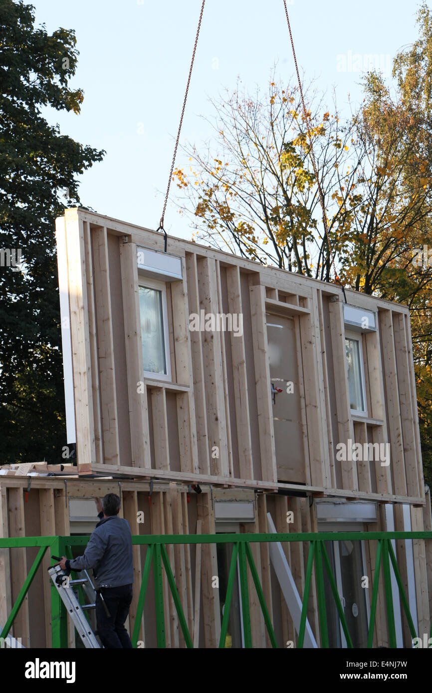 Crane hoisting up a prefabricated wall Stock Photo - Alamy