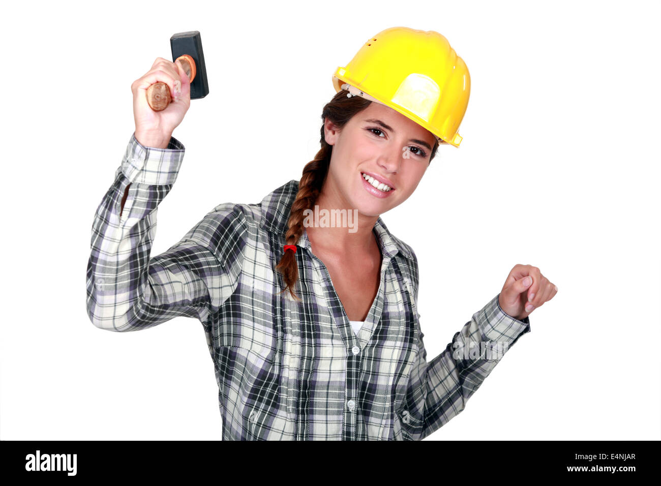 Happy female worker holding hammer Stock Photo - Alamy